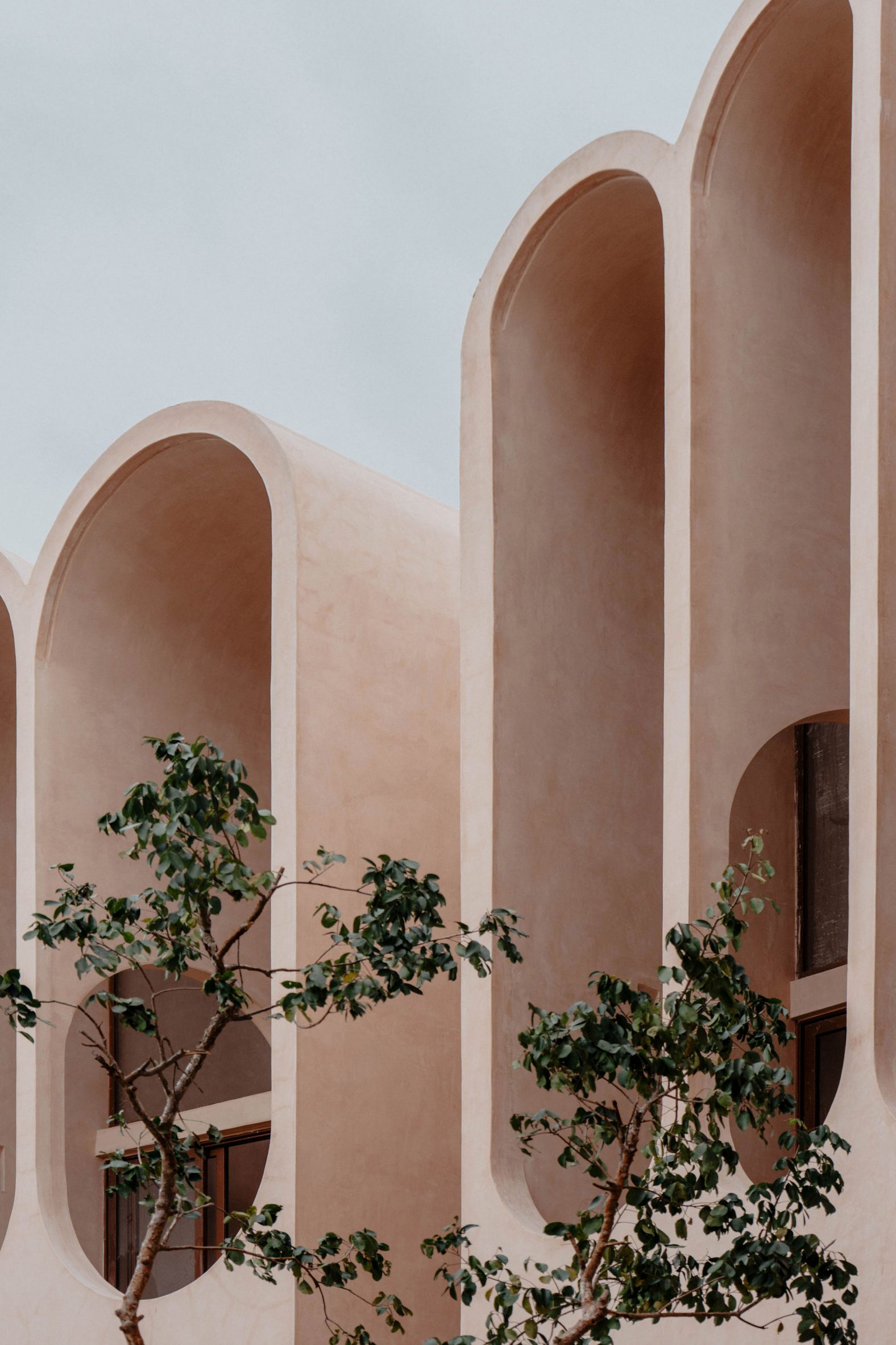 news: earthy-pink babel housing in tulum bridges ancient symbolism with ...