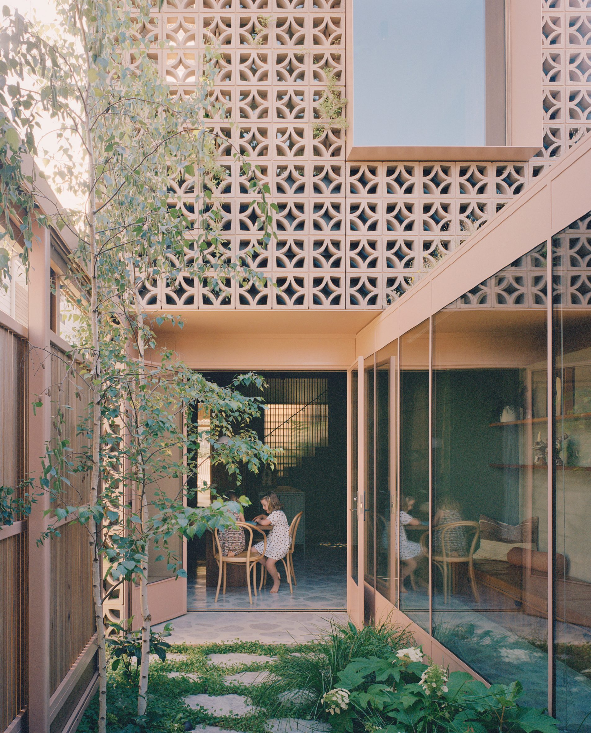 garden tower house combines a serene garden and soft hues to reinforce ...