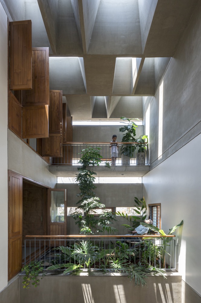 a threshold harmonizes nature and architecture in the compact and ...