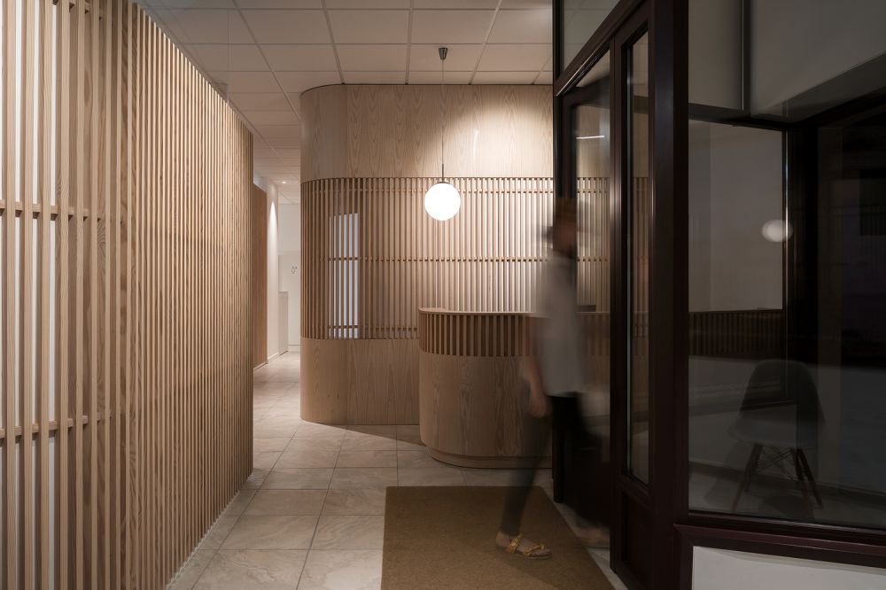 a contemplative physiotherapy center wrapped in smooth wooden interior ...