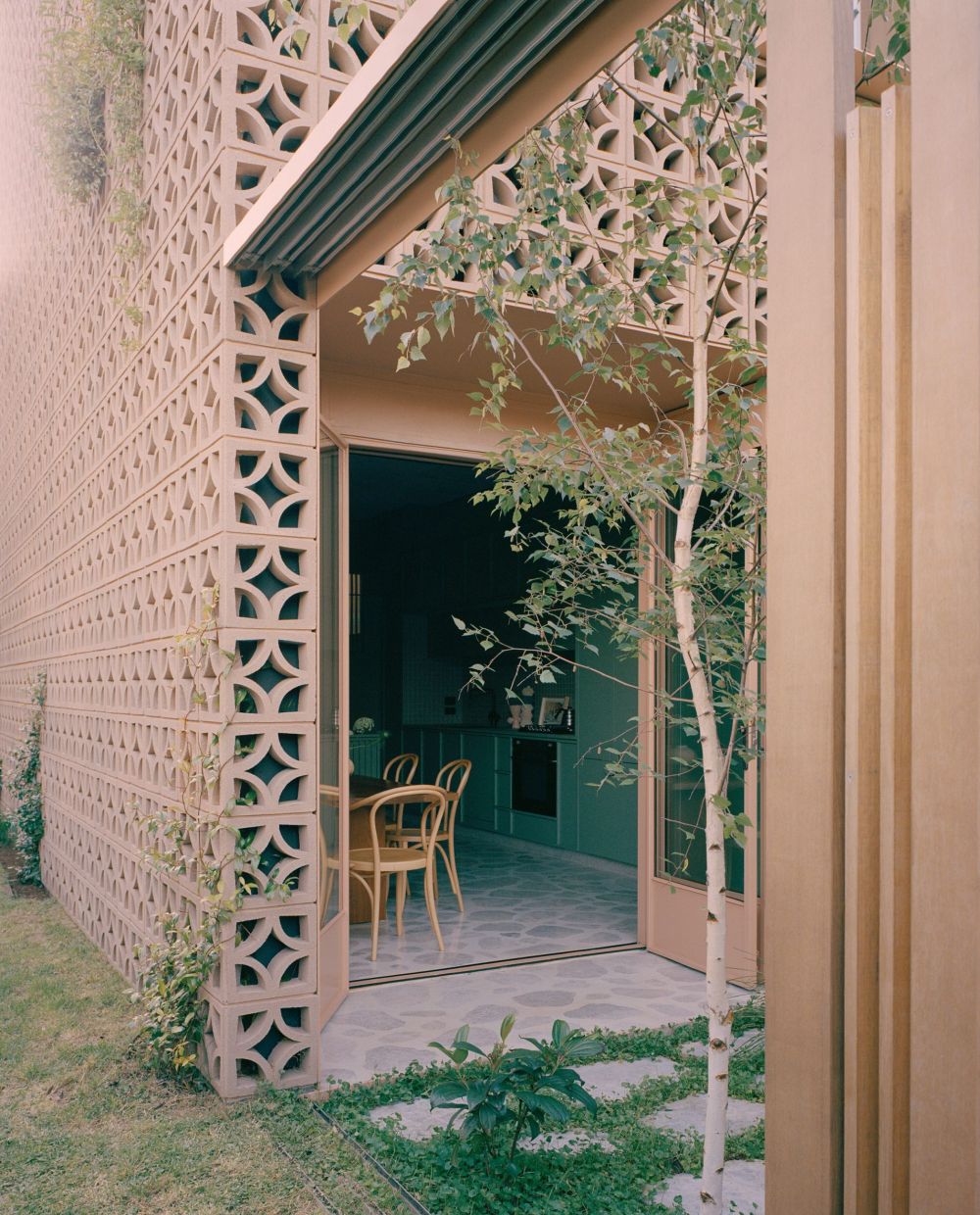 garden tower house combines a serene garden and soft hues to reinforce ...
