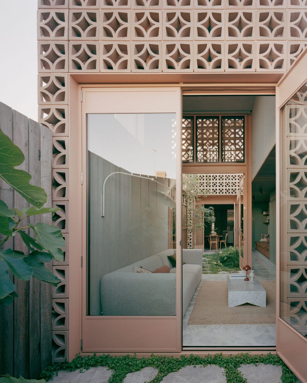 garden tower house combines a serene garden and soft hues to reinforce ...