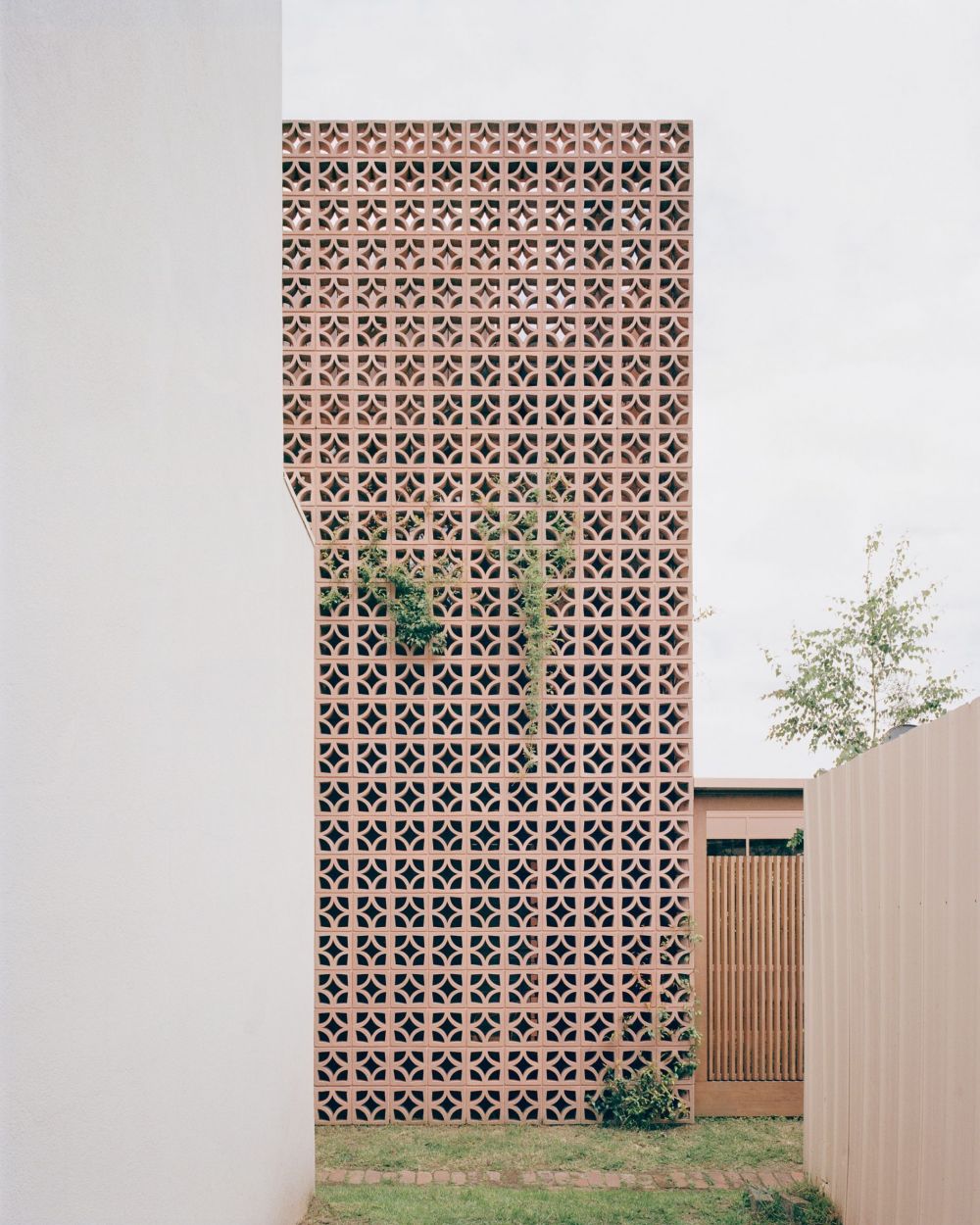 garden tower house combines a serene garden and soft hues to reinforce ...