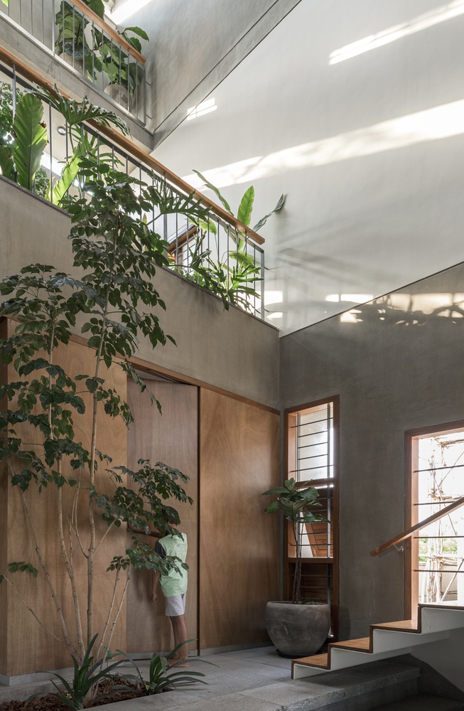 a threshold harmonizes nature and architecture in the compact and ...