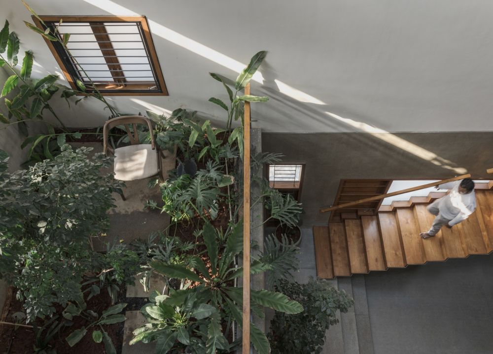 a threshold harmonizes nature and architecture in the compact and ...