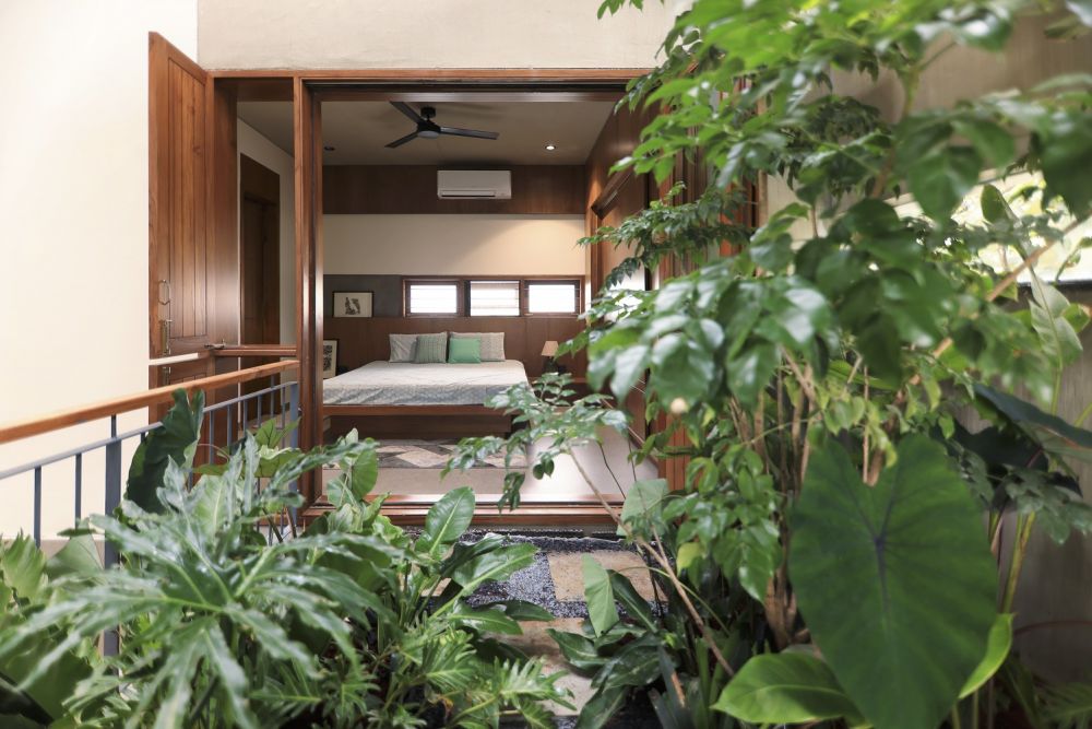 a threshold harmonizes nature and architecture in the compact and ...