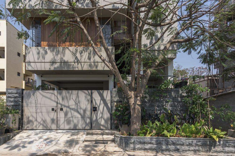 a threshold harmonizes nature and architecture in the compact and ...