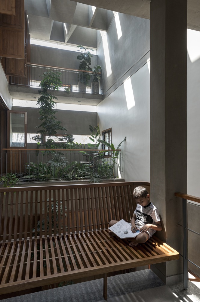 a threshold harmonizes nature and architecture in the compact and ...
