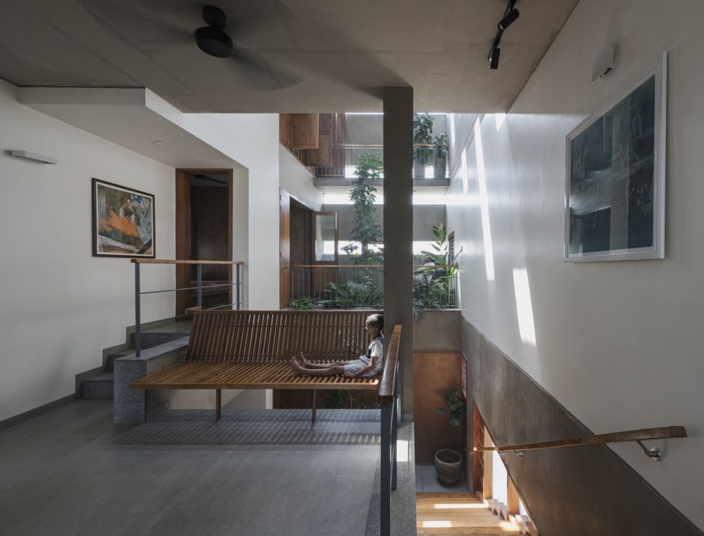 a threshold harmonizes nature and architecture in the compact and ...