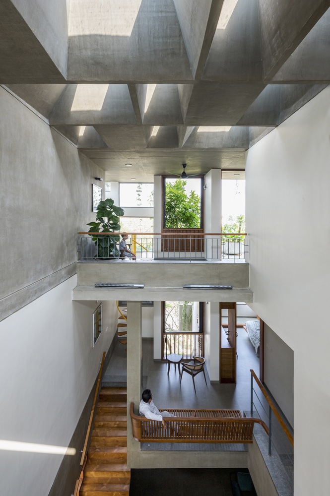 a threshold harmonizes nature and architecture in the compact and ...