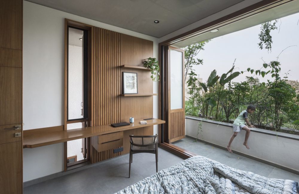 a threshold harmonizes nature and architecture in the compact and ...