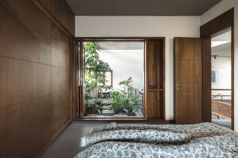 a threshold harmonizes nature and architecture in the compact and ...
