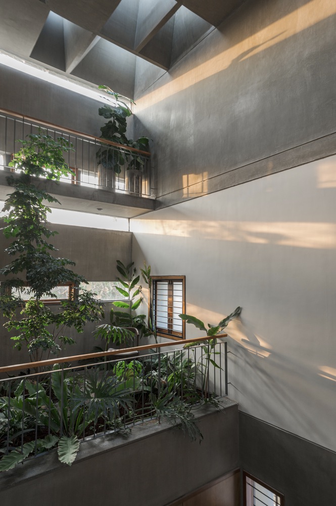 a threshold harmonizes nature and architecture in the compact and ...