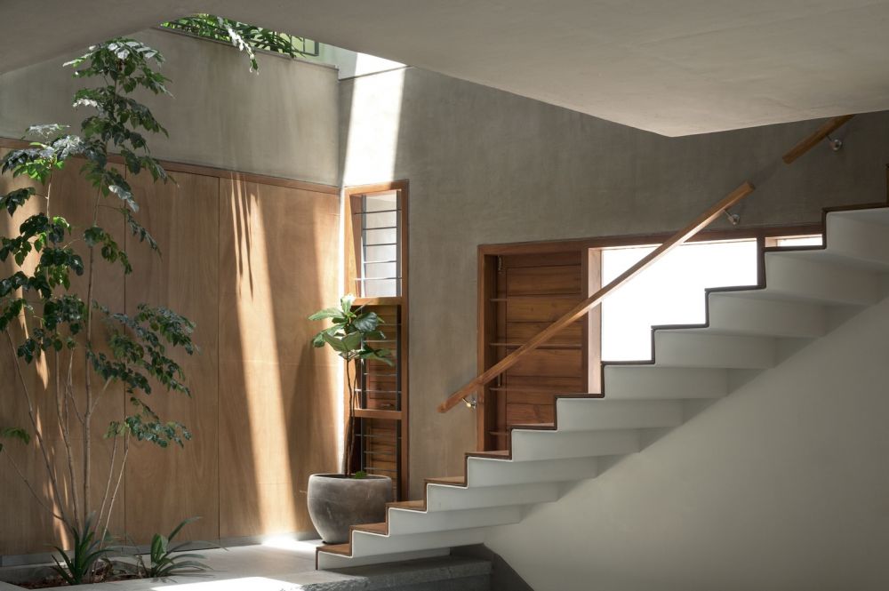 a threshold harmonizes nature and architecture in the compact and ...
