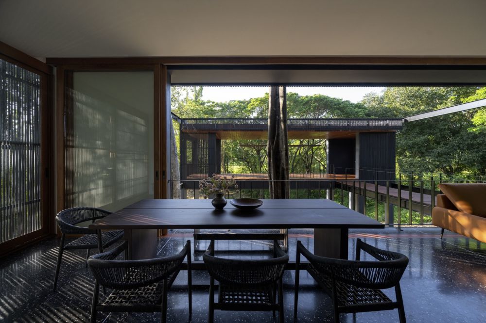 the stilted jomthong raintree house nurtures a harmonious coexistence ...